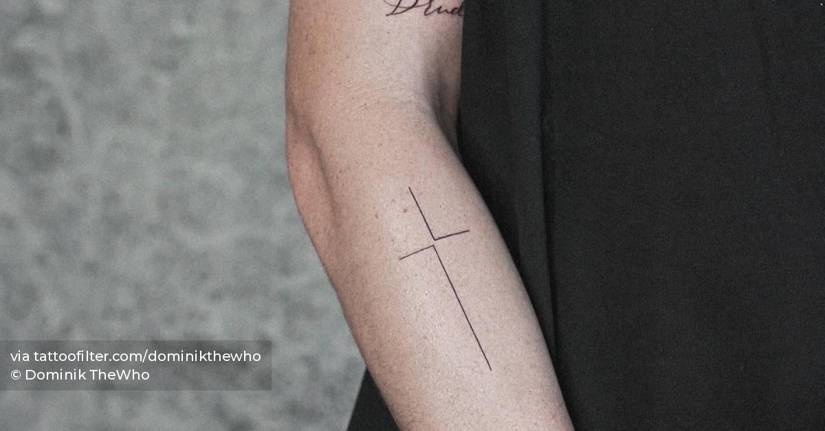 Letter "L" in the shape of a cross tattooed on the