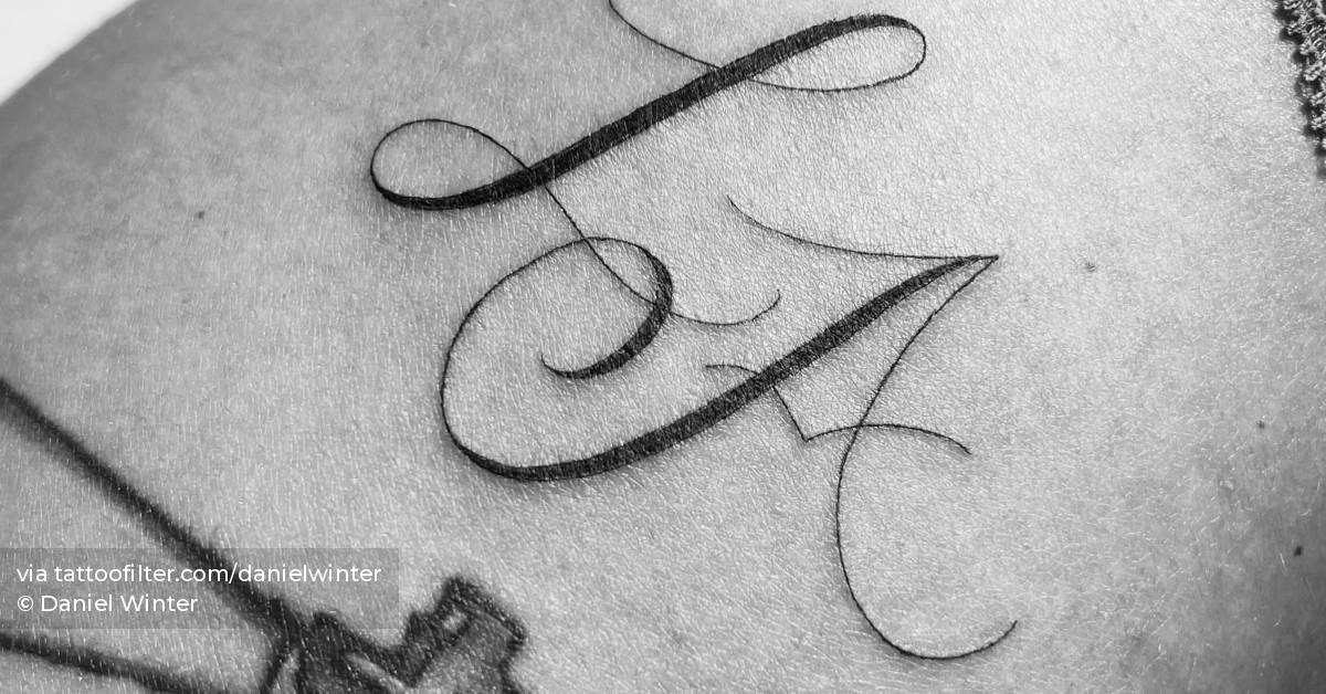 "LA" lettering tattoo located on Mina Mendes' hip.