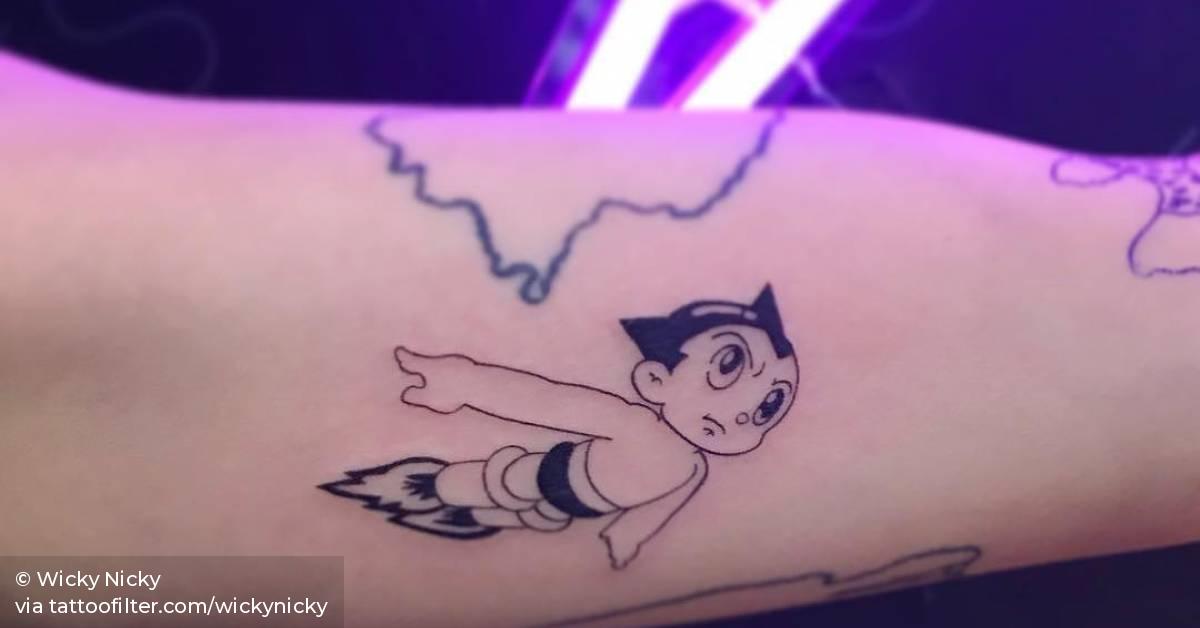Astro boy tattoo on the inner arm.