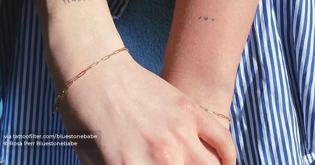 Matching hand poked "tender joy" lettering tattoo for