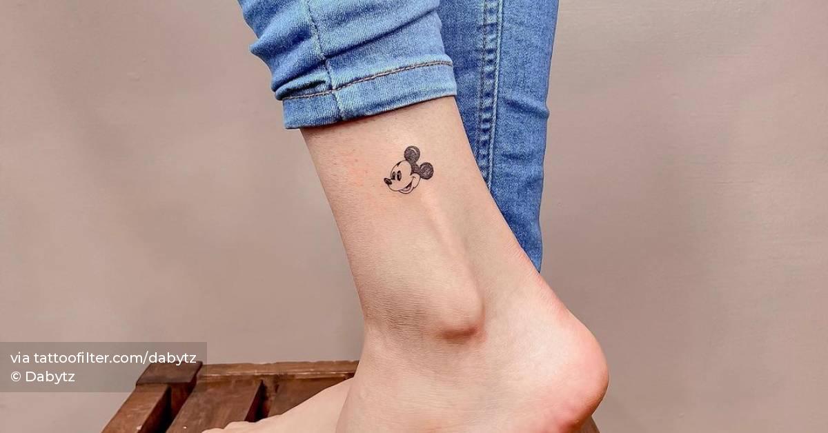 Cartoon style Mickey Mouse tattoo located on the ankle.