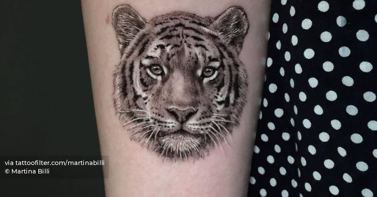 Micro-realistic tiger portrait tattoo on the inner