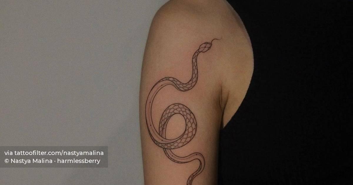Fine line snake tattoo located on the upper arm.