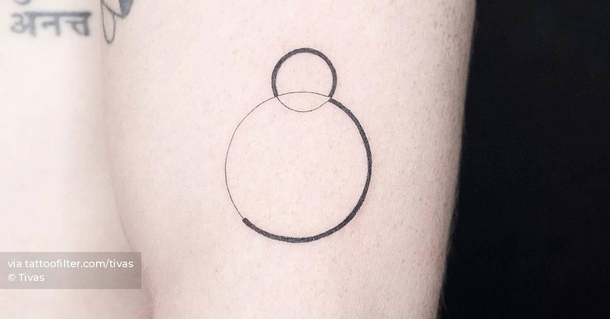 Minimalistic style circles tattooed on the upper arm.
