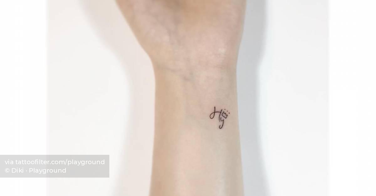 Initials and crow tattooed on the wrist, minimalistic