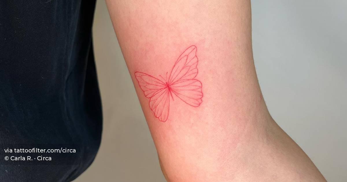 Fine line red butterfly tattoo located on the inner