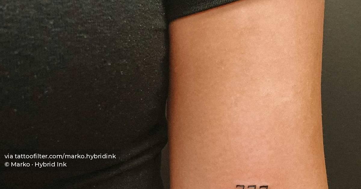 Tattoo of the number "777" located on the bicep.