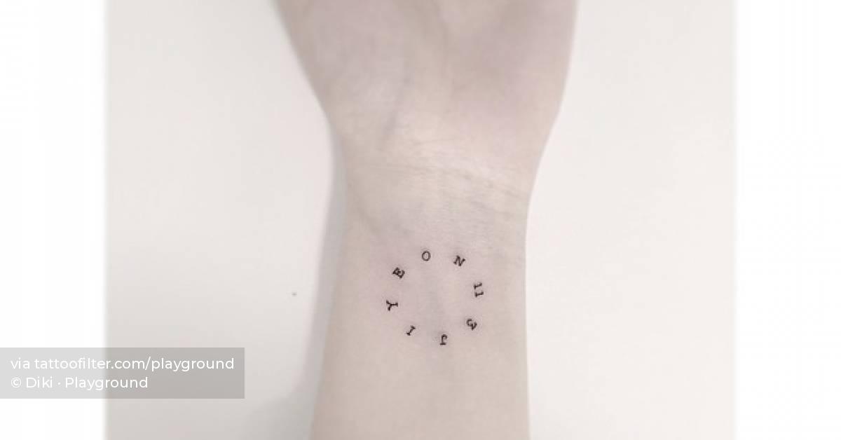 Lettering tattoo in a circle shape done on the wrist.