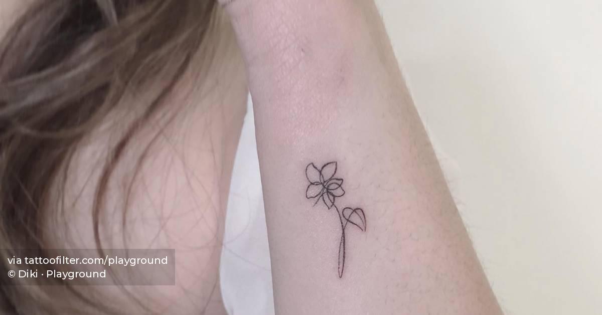 One line flower tattoo located on the wrist.