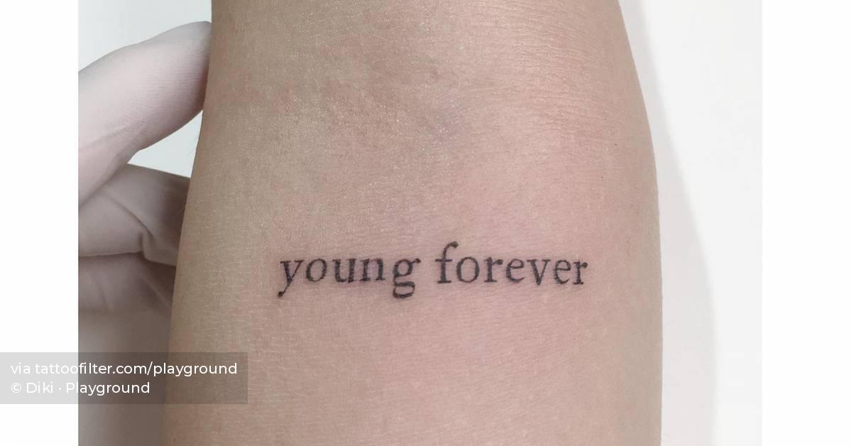Tattoo that says "young forever" located on the inner