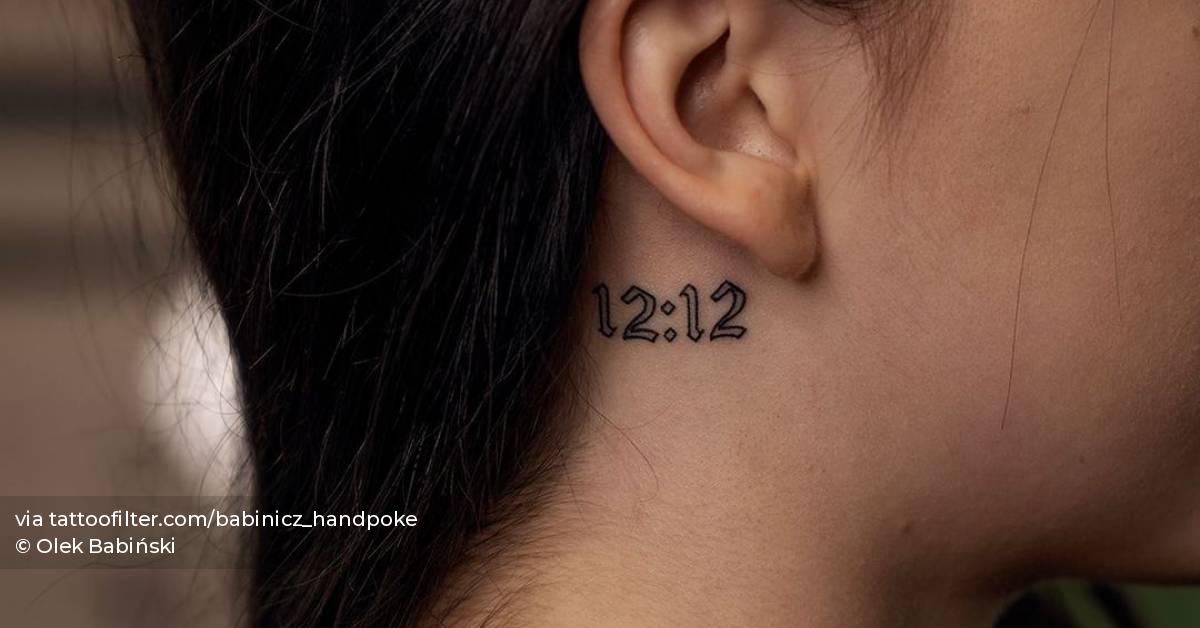 "12:12" tattoo hand poked behind the ear.