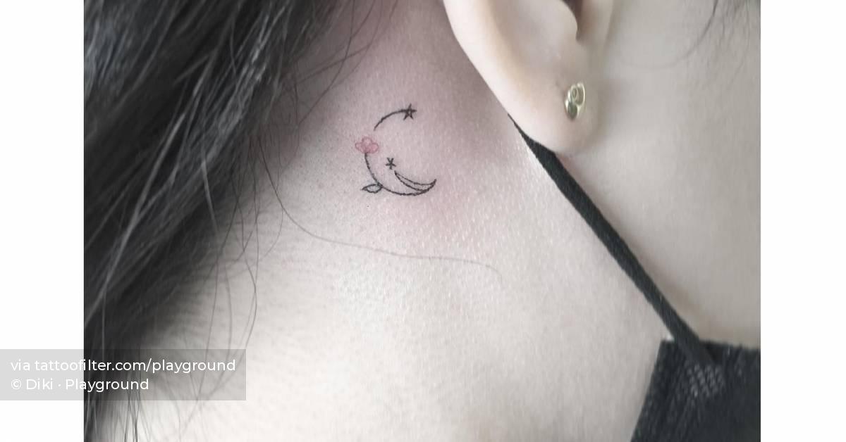 Minimalistic flower moon tattoo located behind the ear.