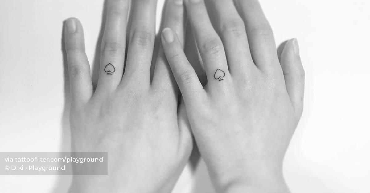 Matching minimalistic spades suit tattoo for couple.