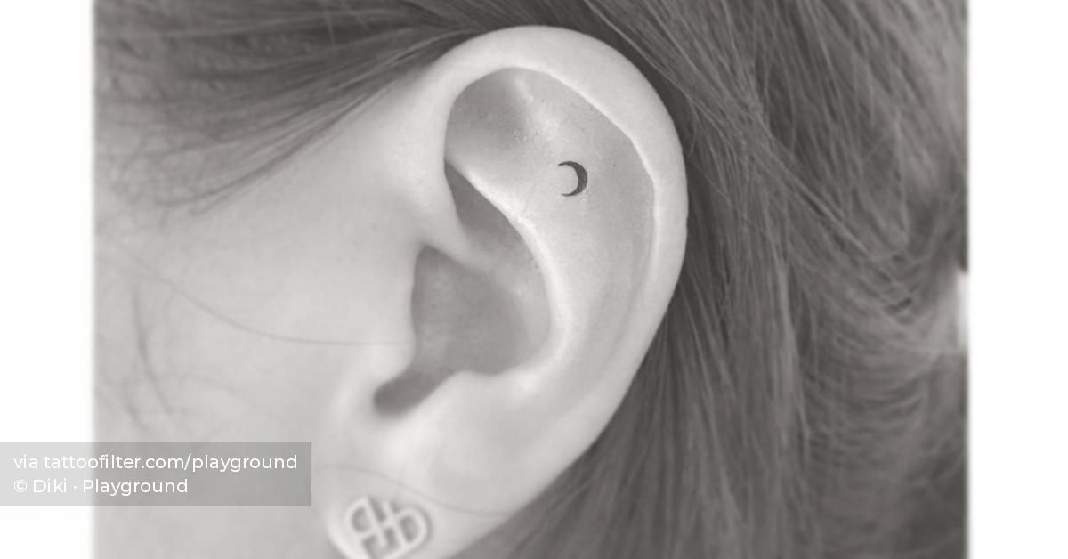 Micro crescent moon done on the ear.
