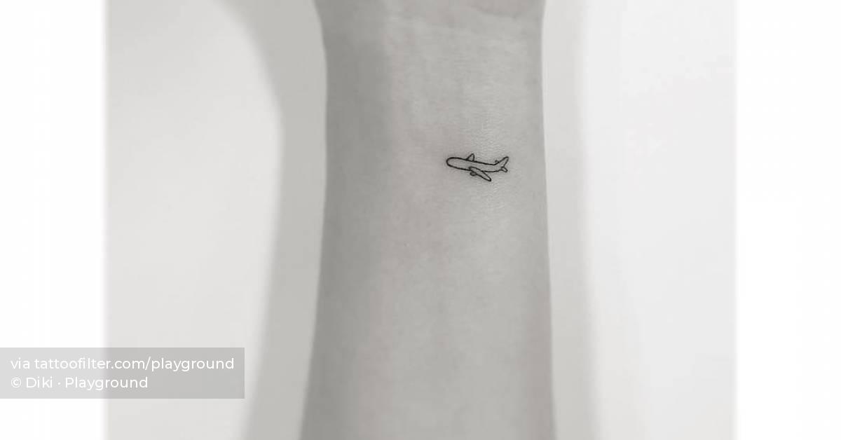 Fine line airplane tattoo located on the wrist,