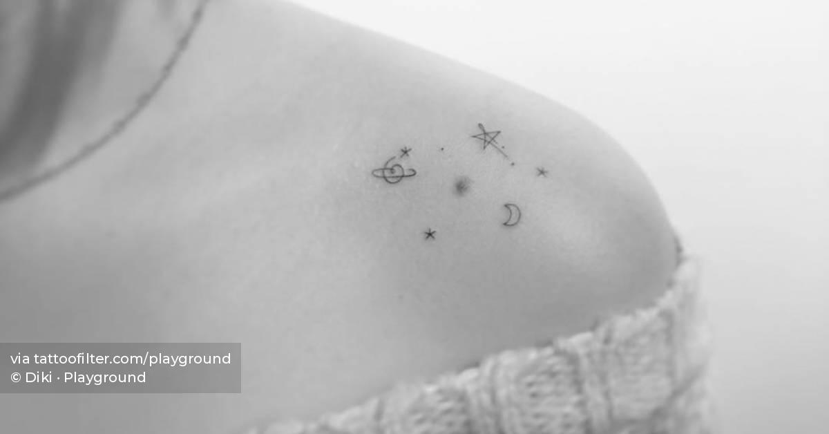 Minimalistic universe tattooed on the shoulder.