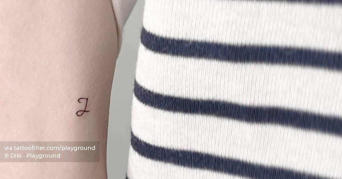Minimalistic letter "J" tattoo done on the inner arm.