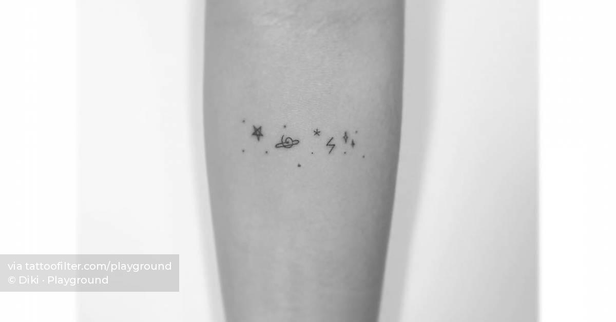 Minimalistic universe tattooed on the inner forearm,.