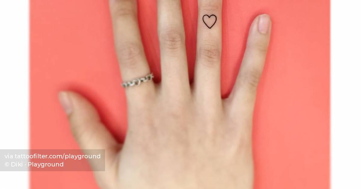 Tiny heart tattoo located on the finger, minimalistic