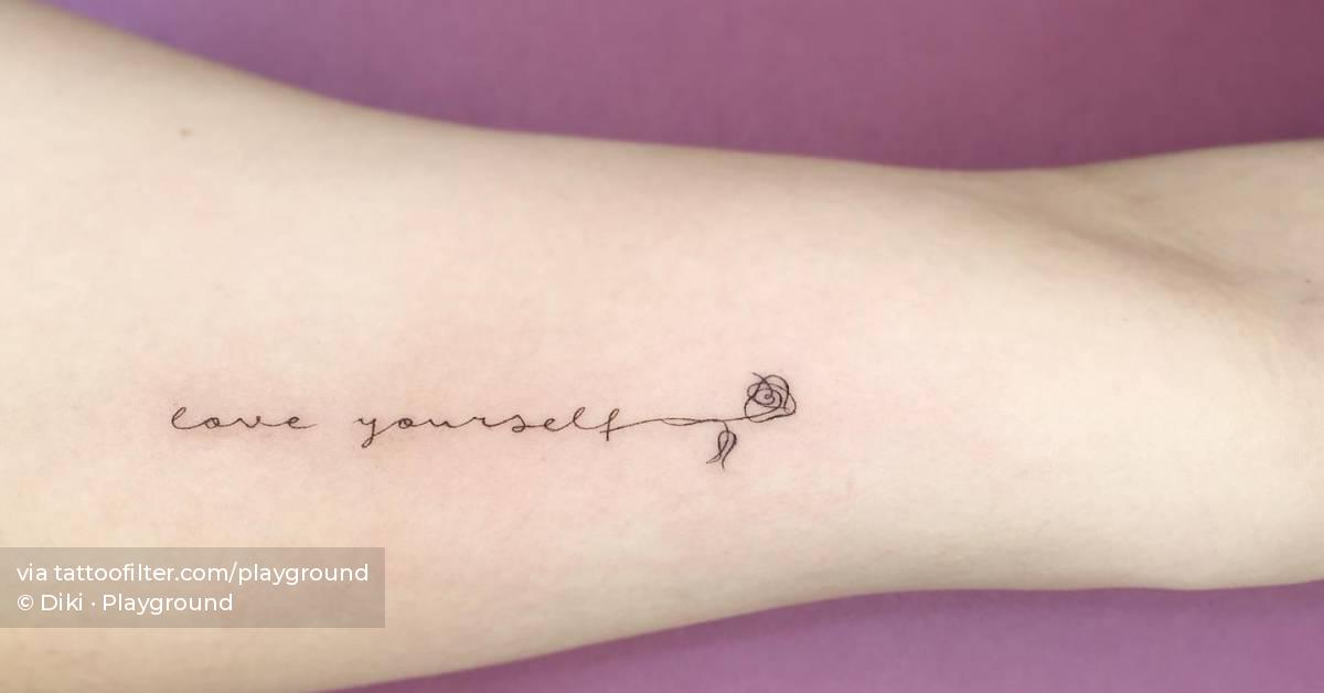 Tattoo that says "love yourself" handwritten on the
