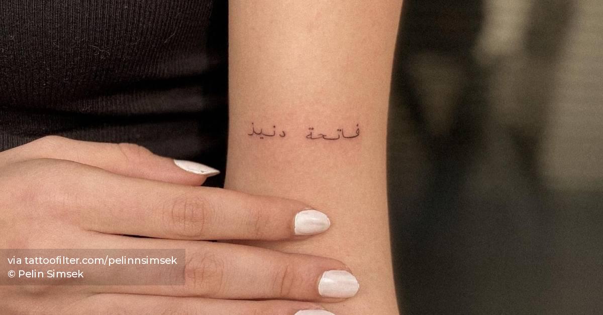 Arabic lettering tattoo located on the bicep.
