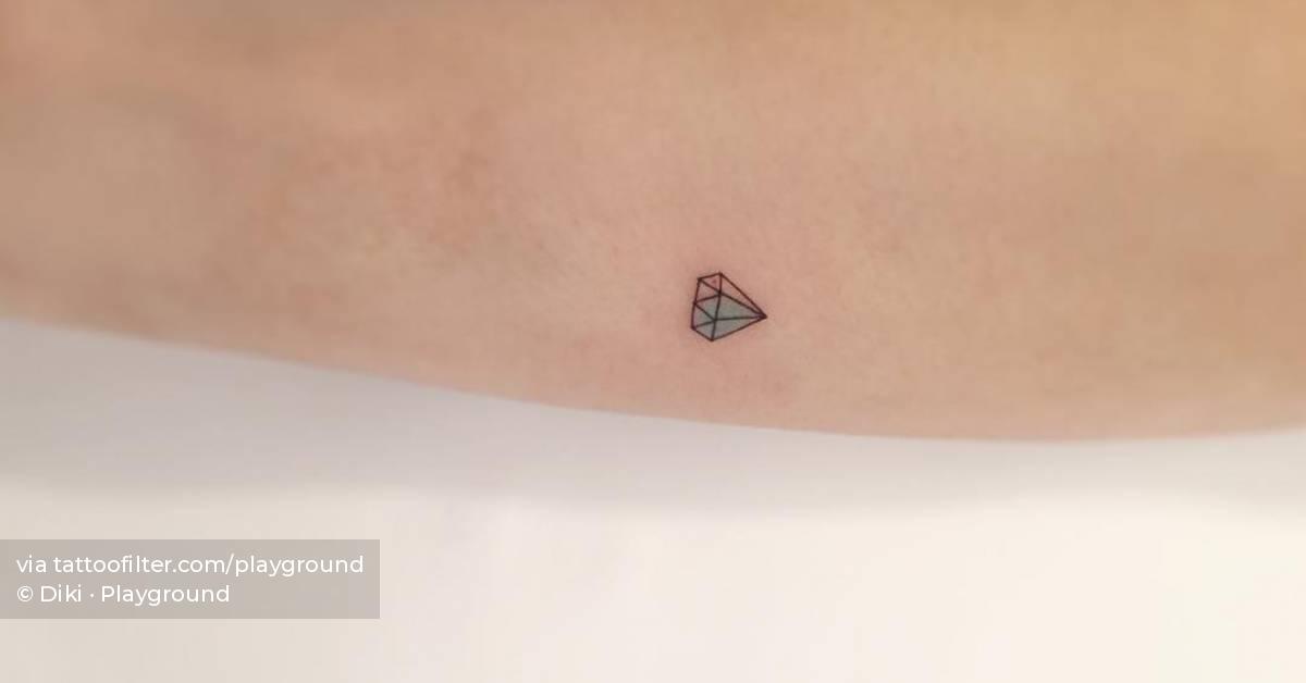 Tiny diamond tattoo located on the inner forearm.