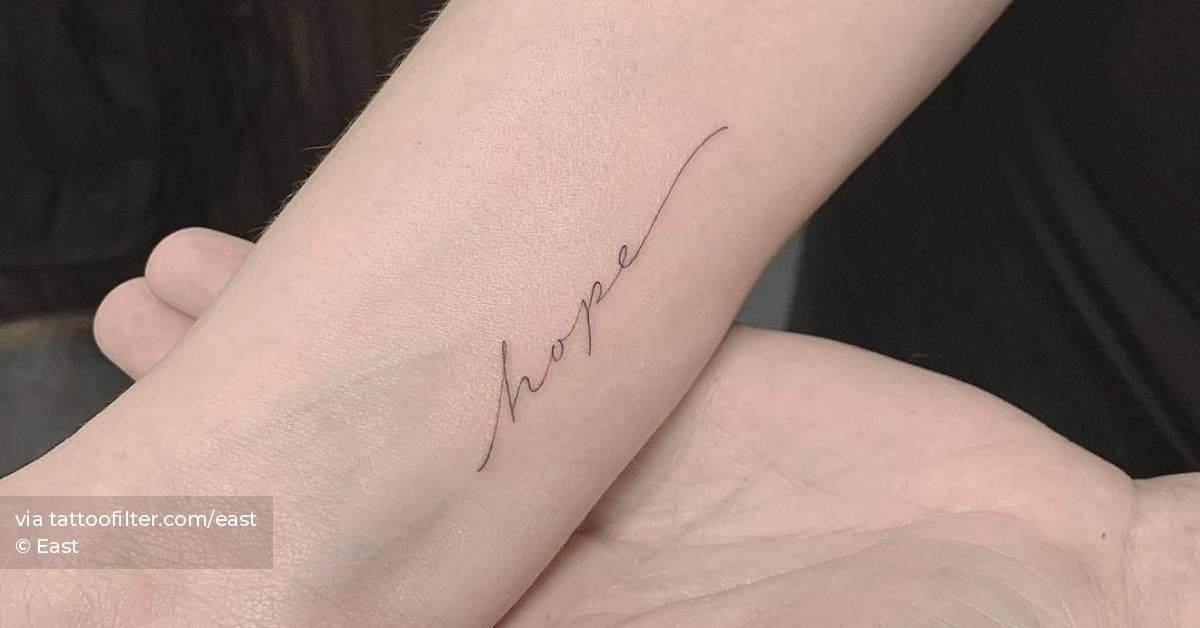 "Hope" lettering tattoo located on the wrist.