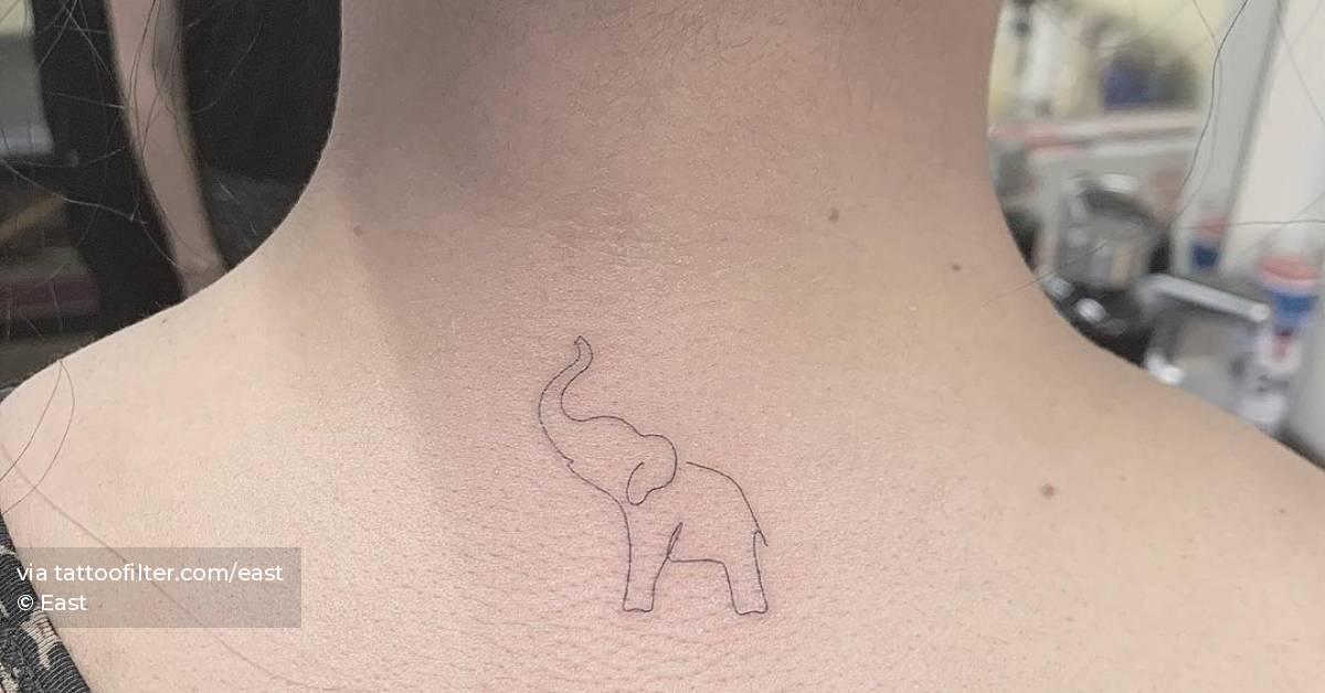 One line elephant tattoo located on the upper back.
