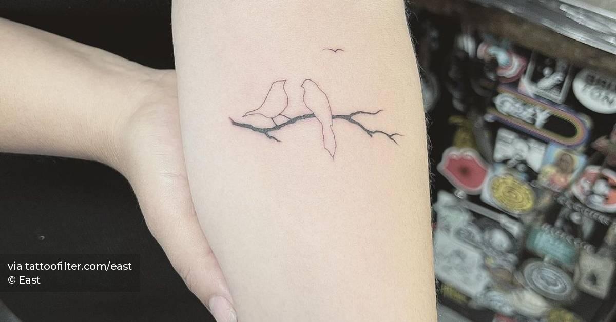 Single needle birds on a branch tattoo located on the