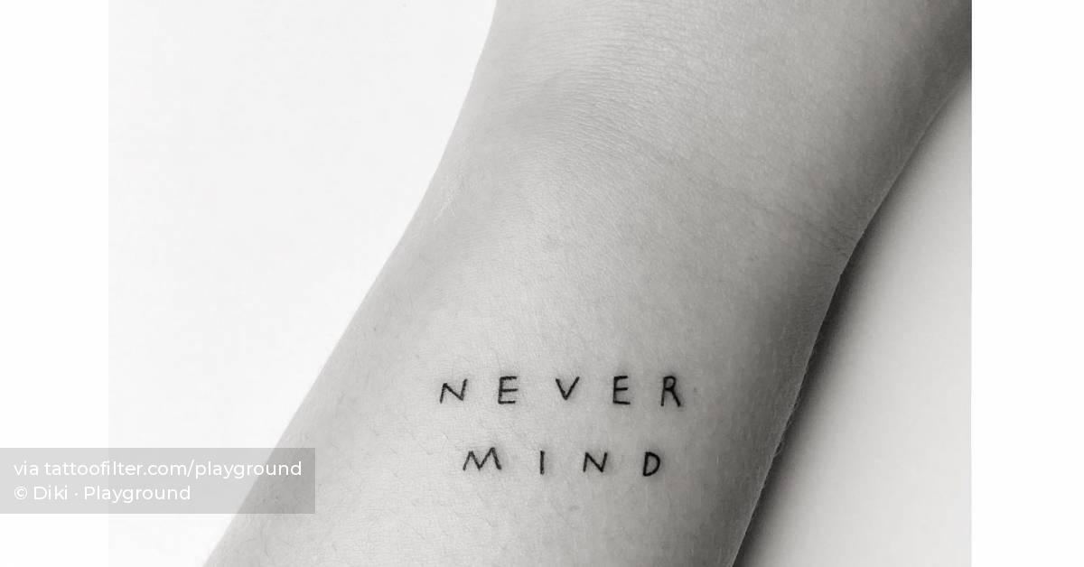 Tattoo that says "nevermind" handwritten on the wrist.