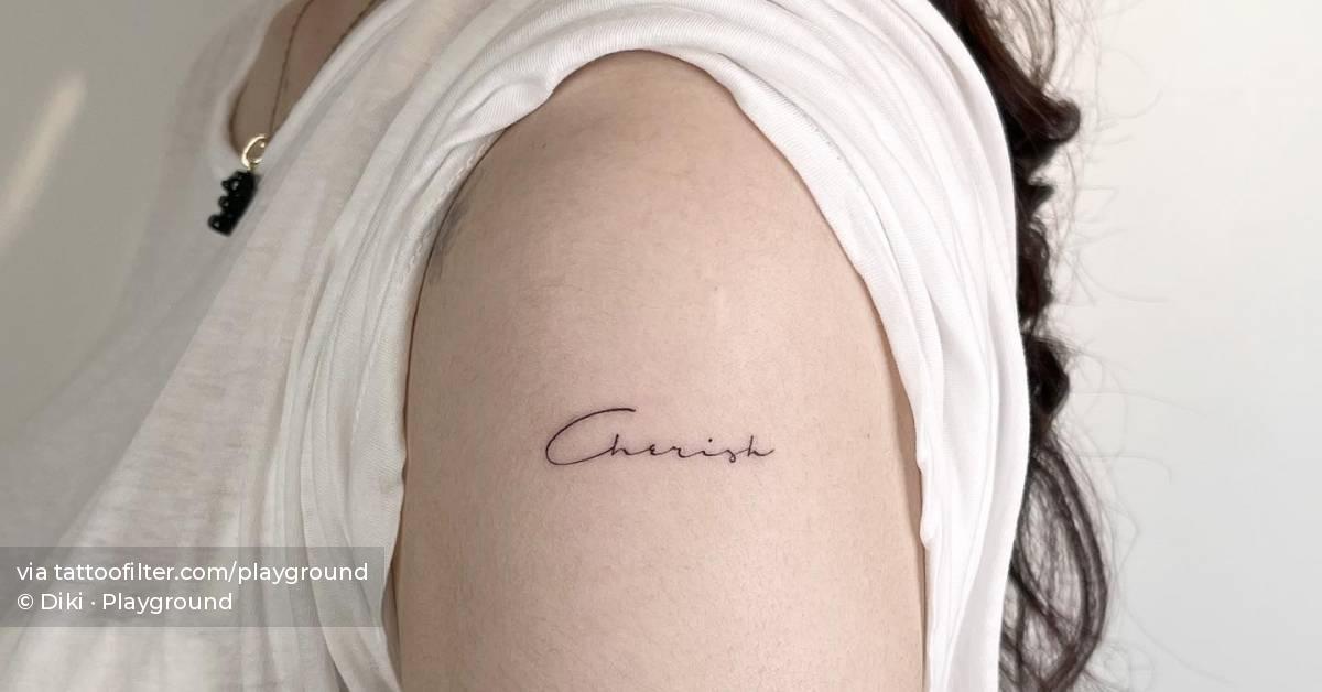 "Cherish" lettering tattoo located on the upper arm.