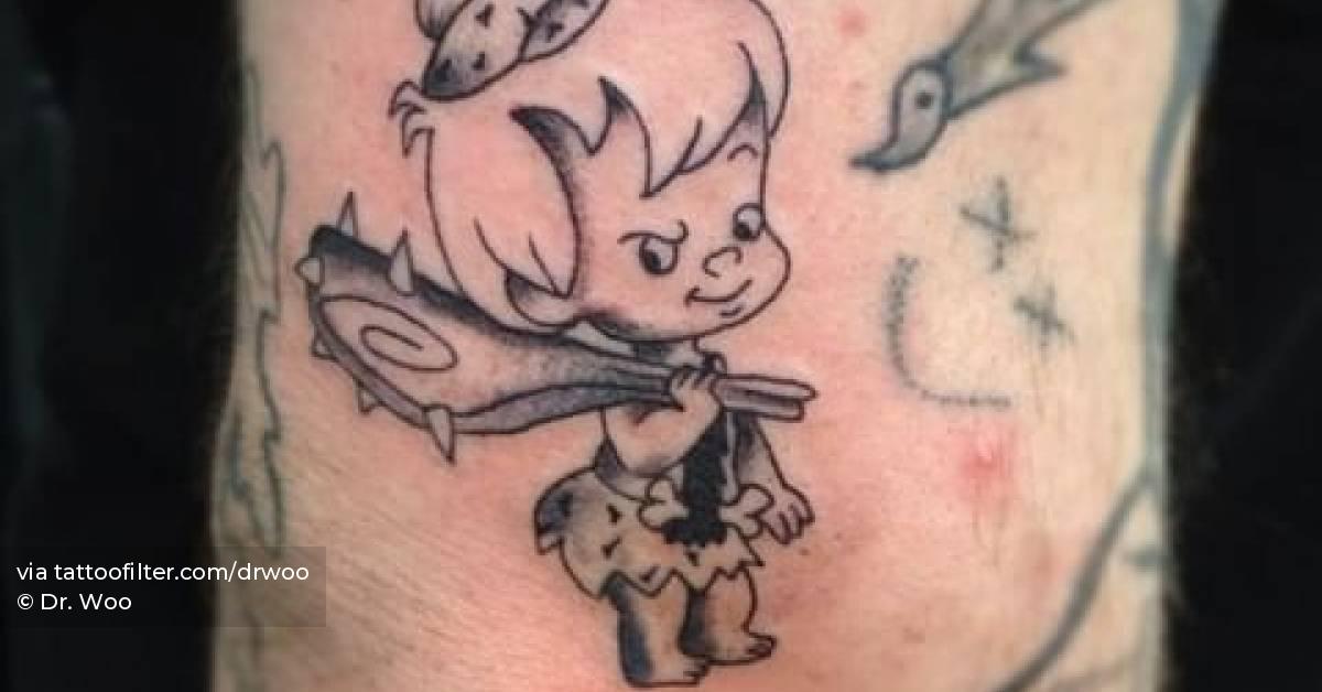 Bamm Bamm Rubble tattoo located on the elbow.