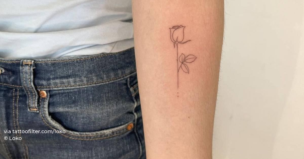 Fine line rose tattoo located on the inner forearm.
