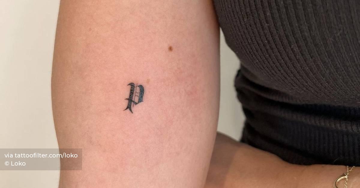 Tattoo of the letter "P" placed on the inner arm.