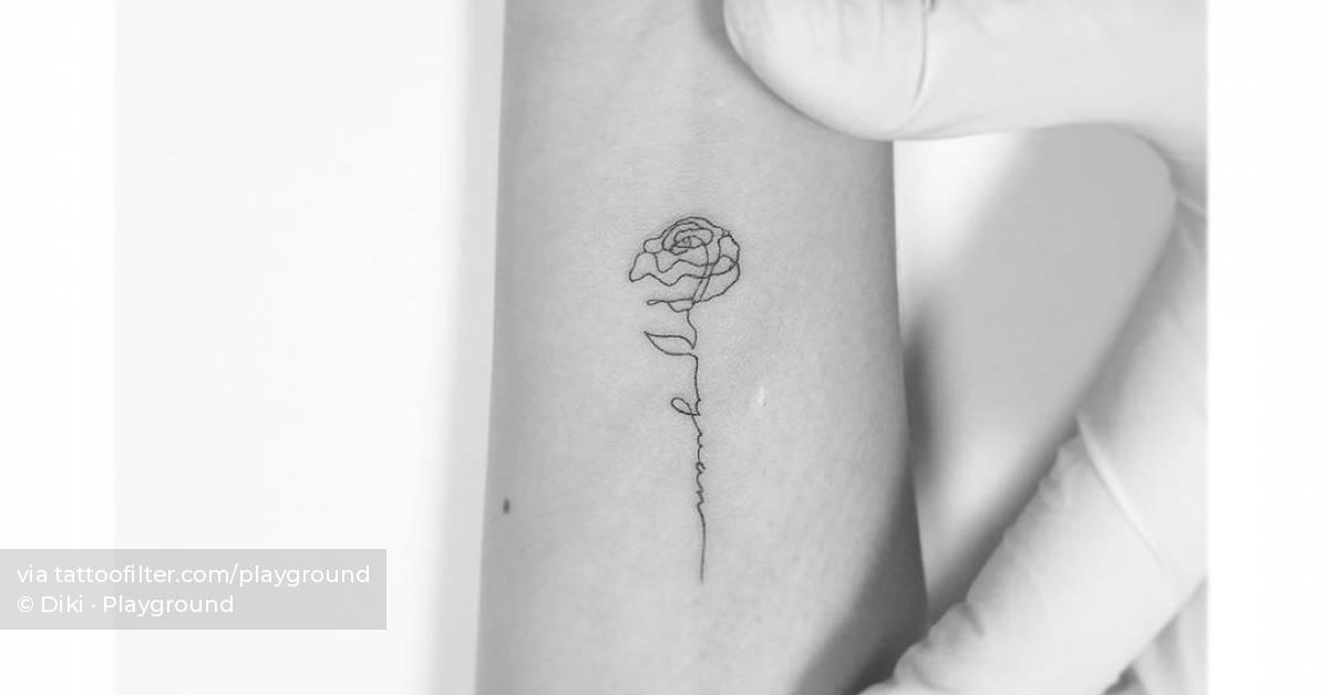 One line rose and name tattooed on the wrist.
