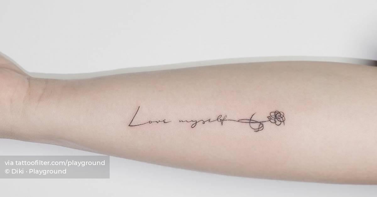 "Love myself" and rose tattooed on the inner forearm.