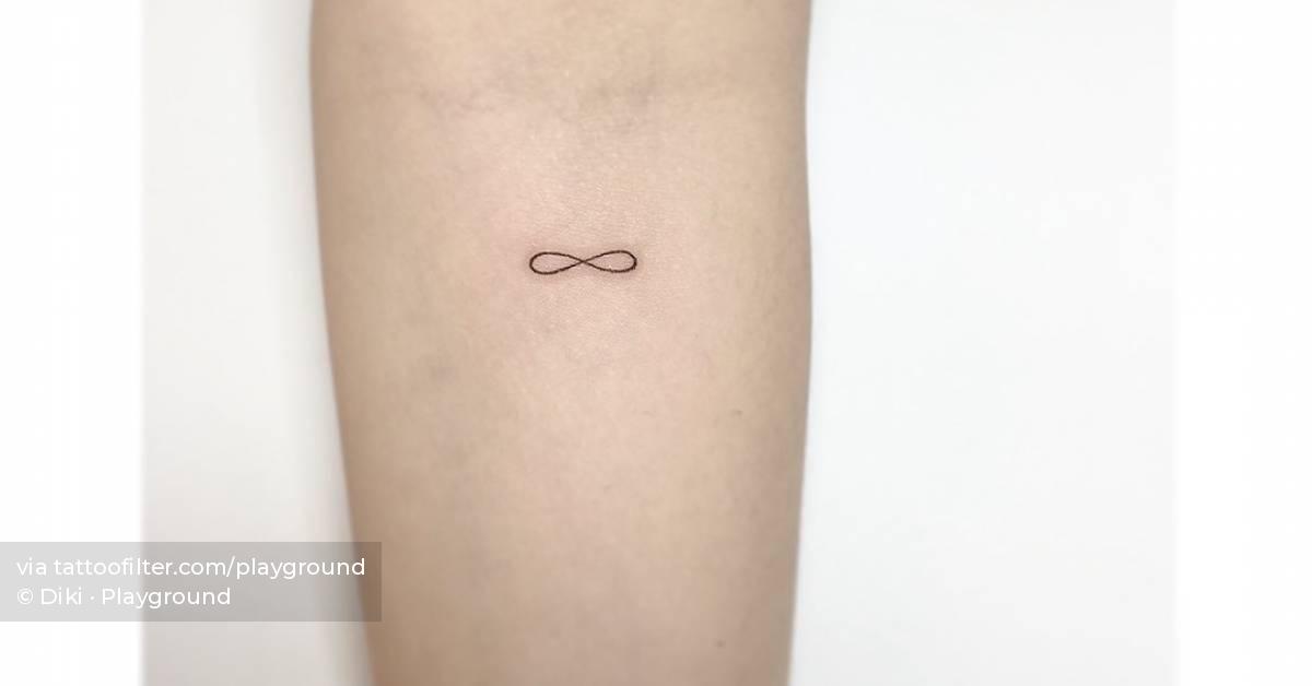 Minimalistic infinity symbol tattoo located on the