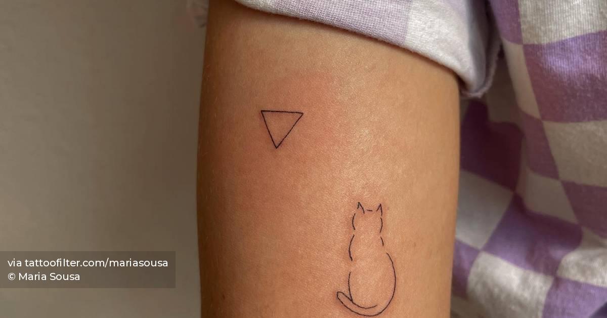 Fine line cat and triangle tattoo located on the inner