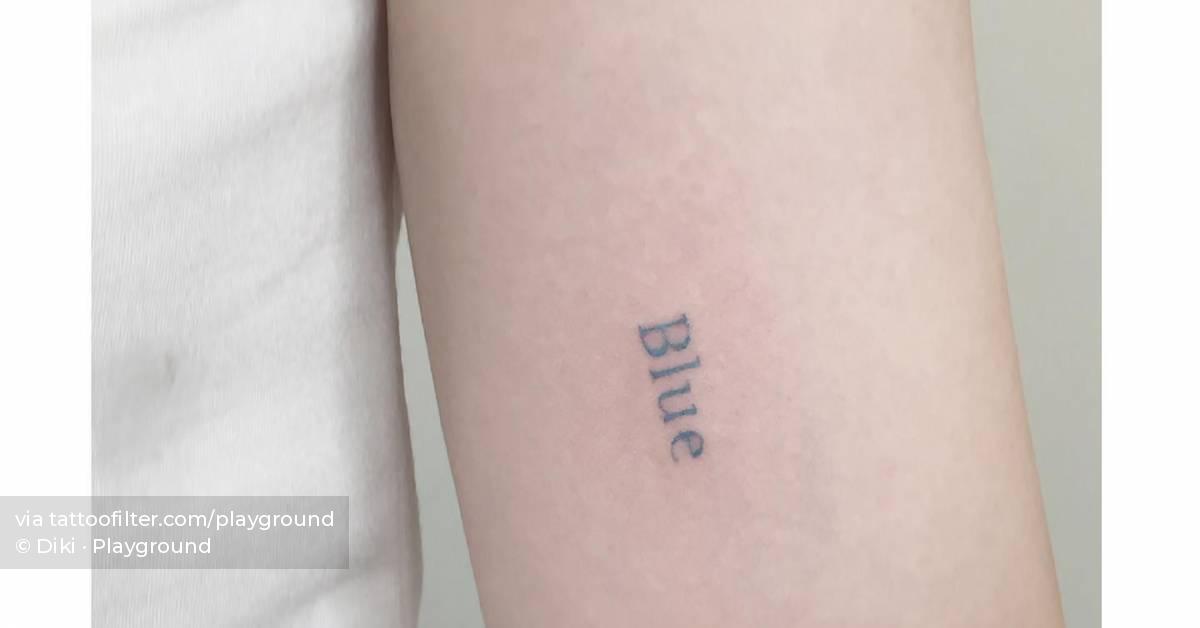 Tattoo of the word "blue" done in blue ink, located on