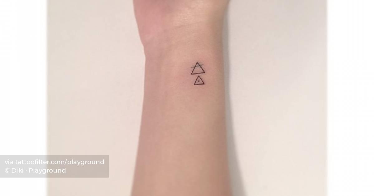 Air and fire symbols tattoed on the wrist.