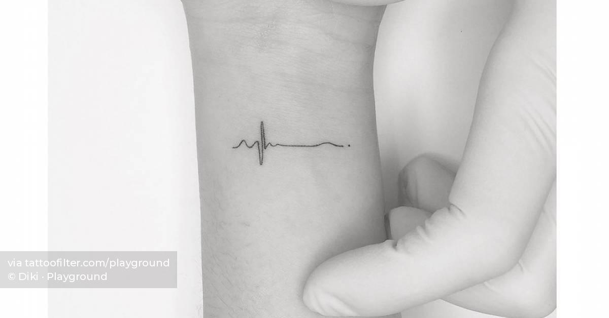 Minimalistic style heartbeat cross tattoo done on the