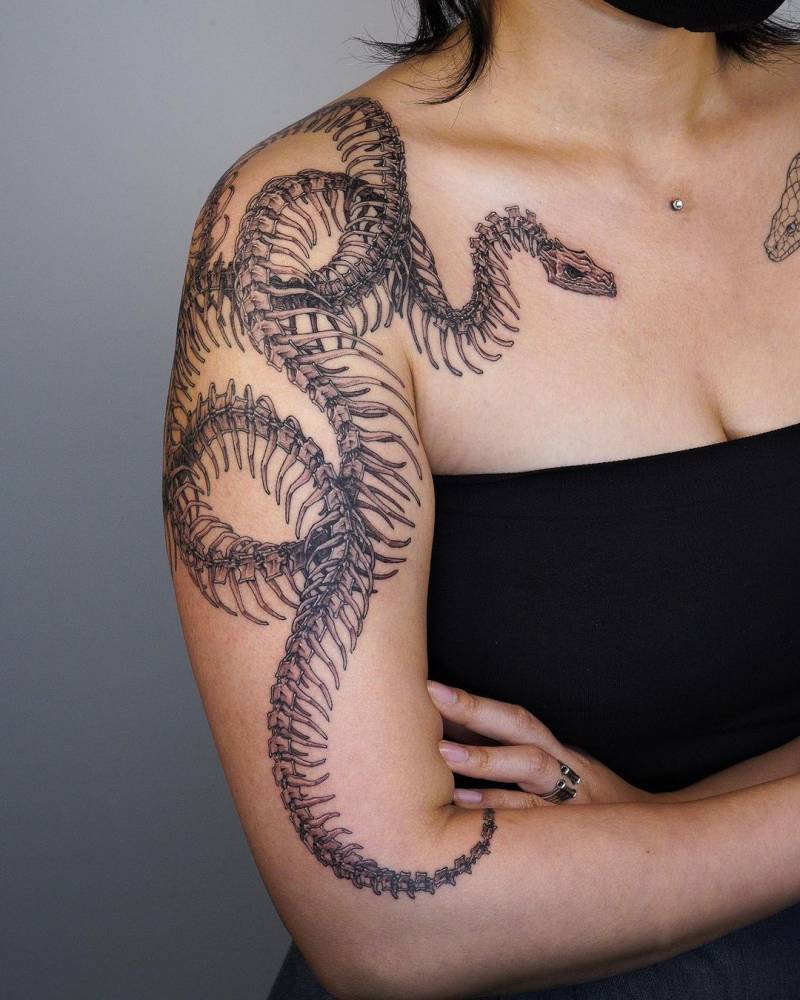 Large Snake Skeleton Tattoo Located On The Upper Arm