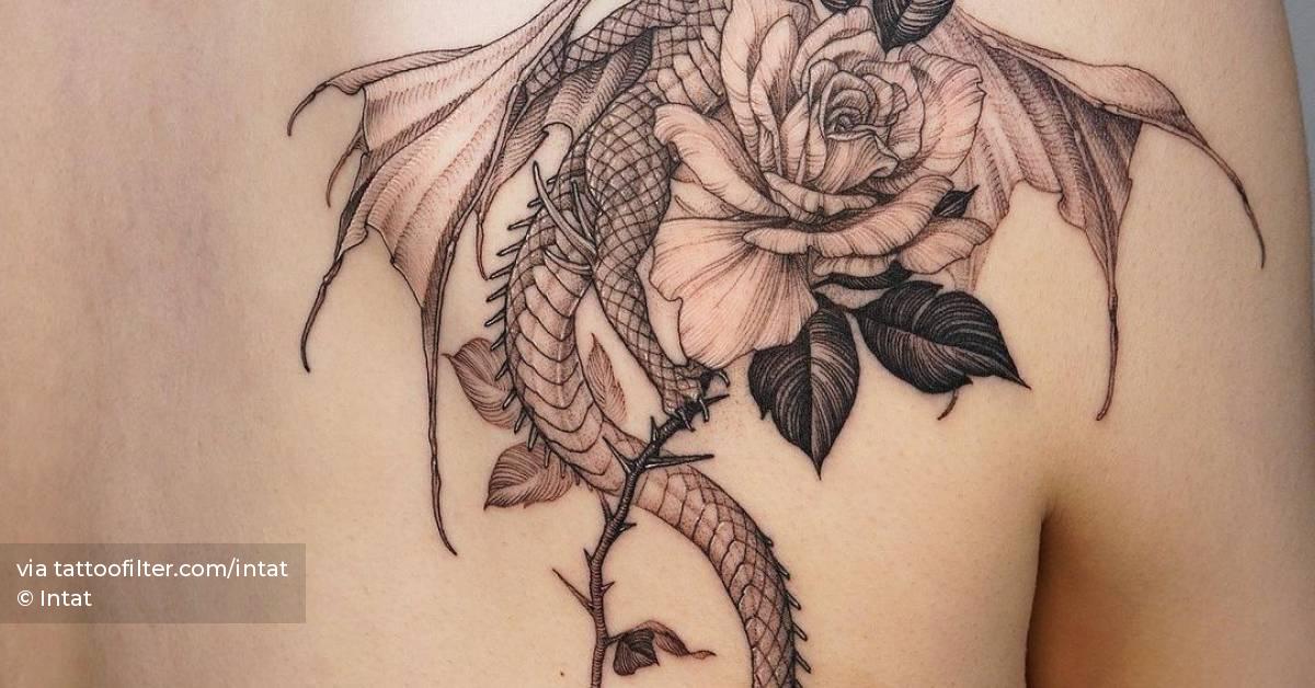 Dragon and rose tattoo located on the shoulder blade.