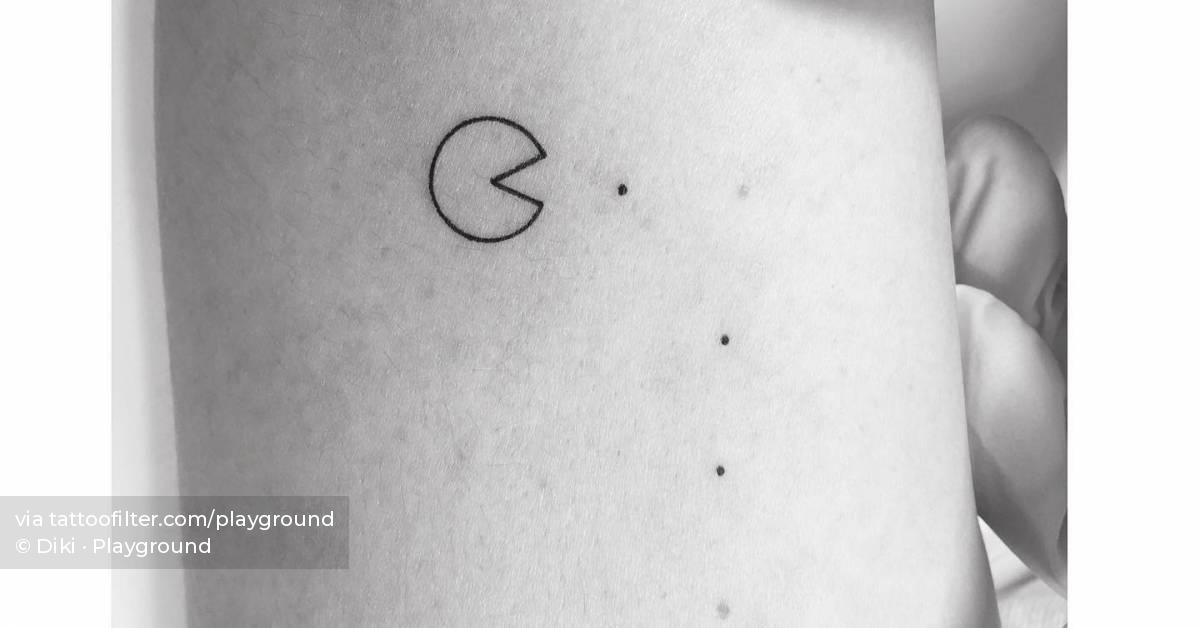 Pac-Man tattoo located on the inner arm, minimalistic