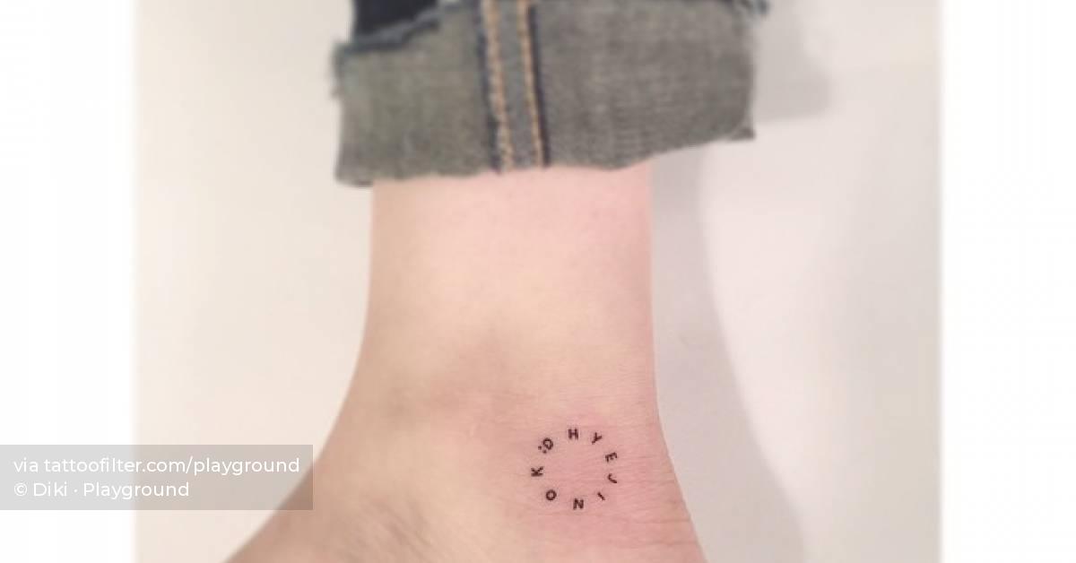 Name tattoo in the shape of a circle.