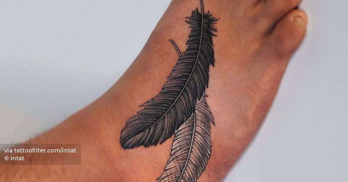 Feathers tattooed on the foot, illustrative style.