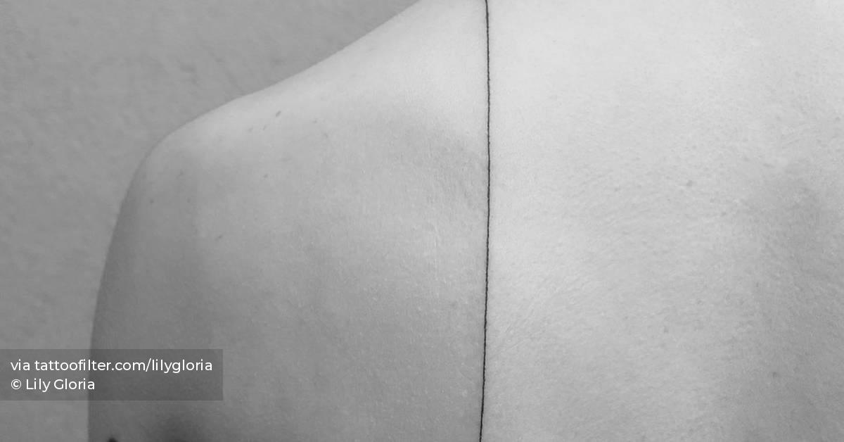 Hand poked line tattoo located on the shoulder blade.