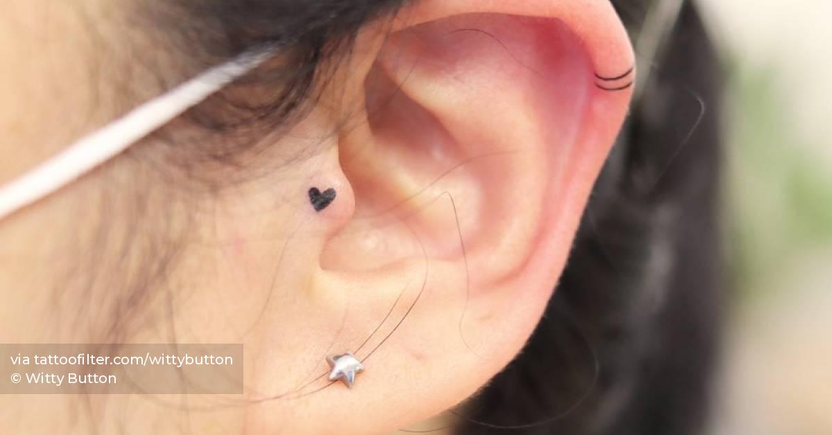 Micro heart and lines tattooed on the ear, minimalistic