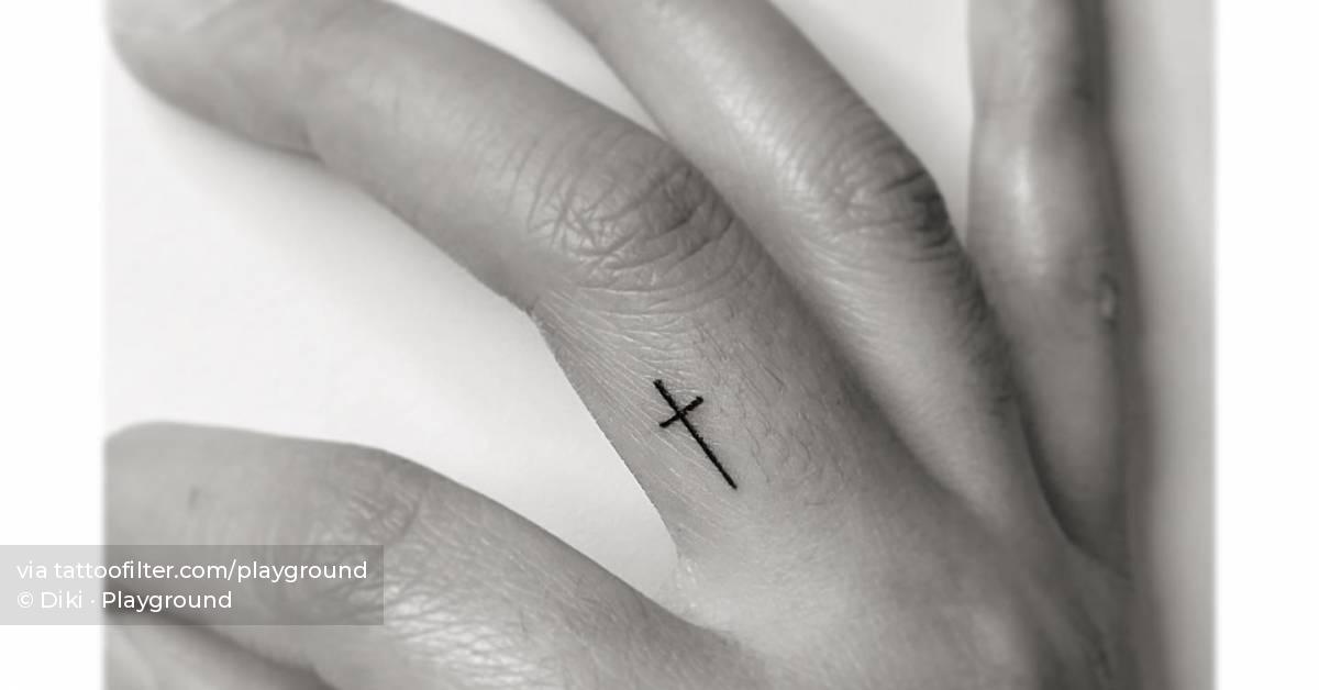 Minimalistic style cross tattooed on the finger.