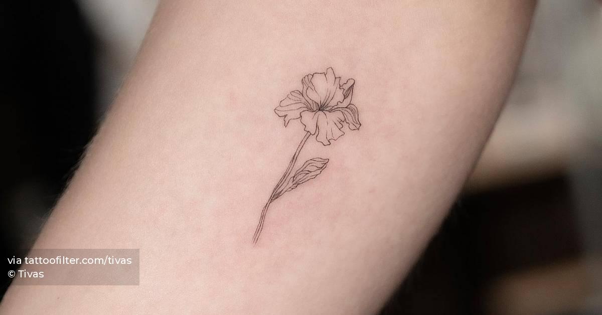 Fine line flower tattoo located on the inner arm.
